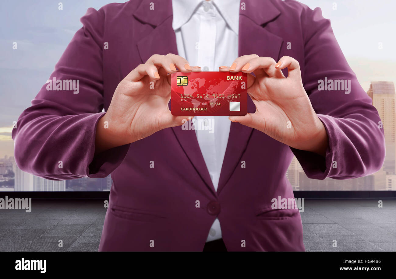 Business woman holding credit card against cityscape background Stock ... Business woman holding credit card against cityscape background Stock ...