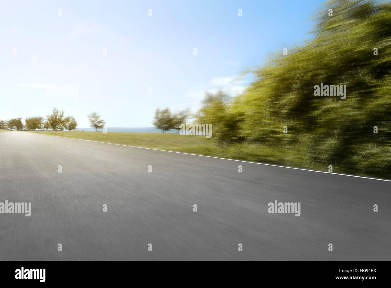 Empty straight road with blue sky and meadow field Stock Photo - Alamy