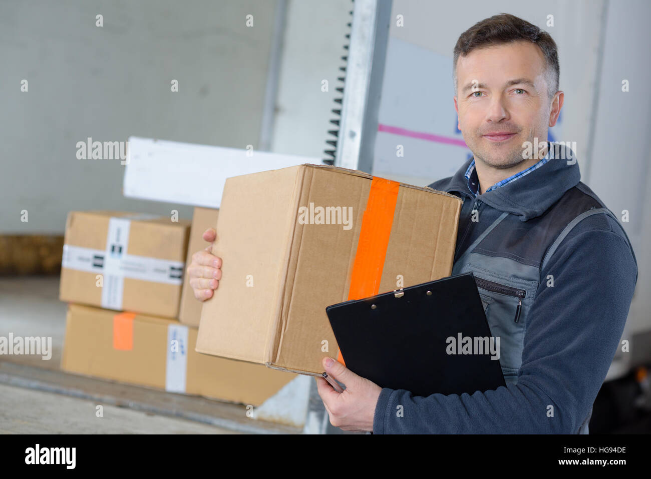 delivery man with parcel near cargo truck shipping service Stock Photo ...