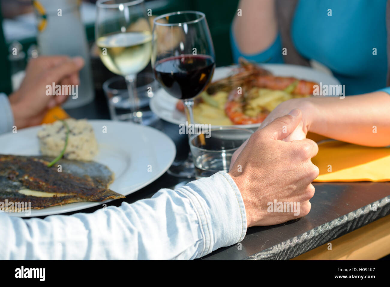 holding hands while eating Stock Photo - Alamy