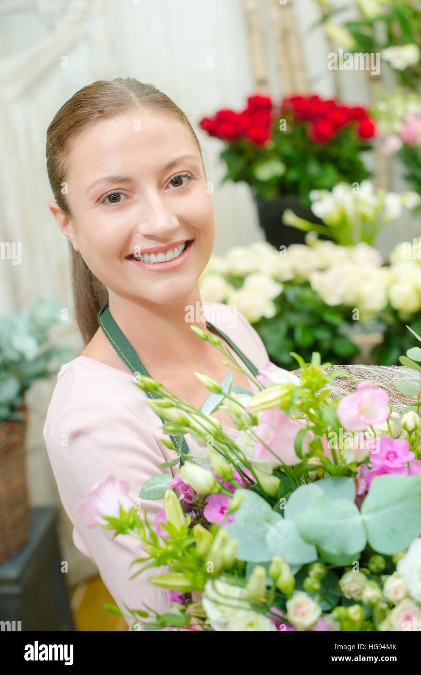 Florist holding bouquet of flowers Stock Photo - Alamy