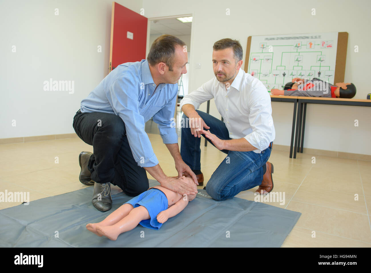 Men at first aid course Stock Photo - Alamy
