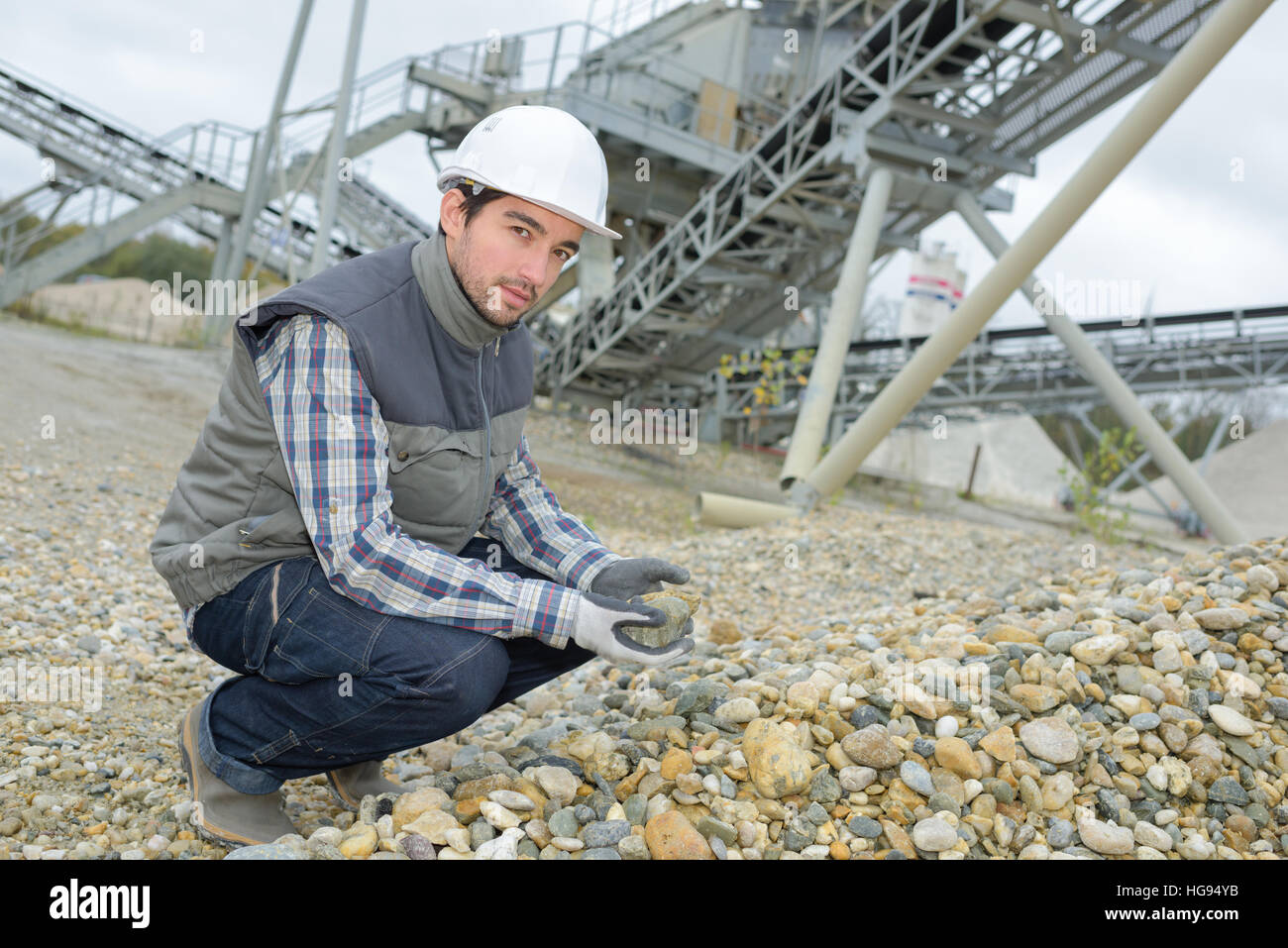 worker holding a rock Stock Photo - Alamy