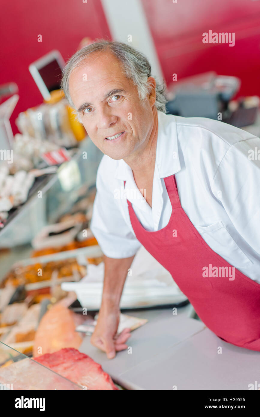 Bucher stood at counter Stock Photo - Alamy