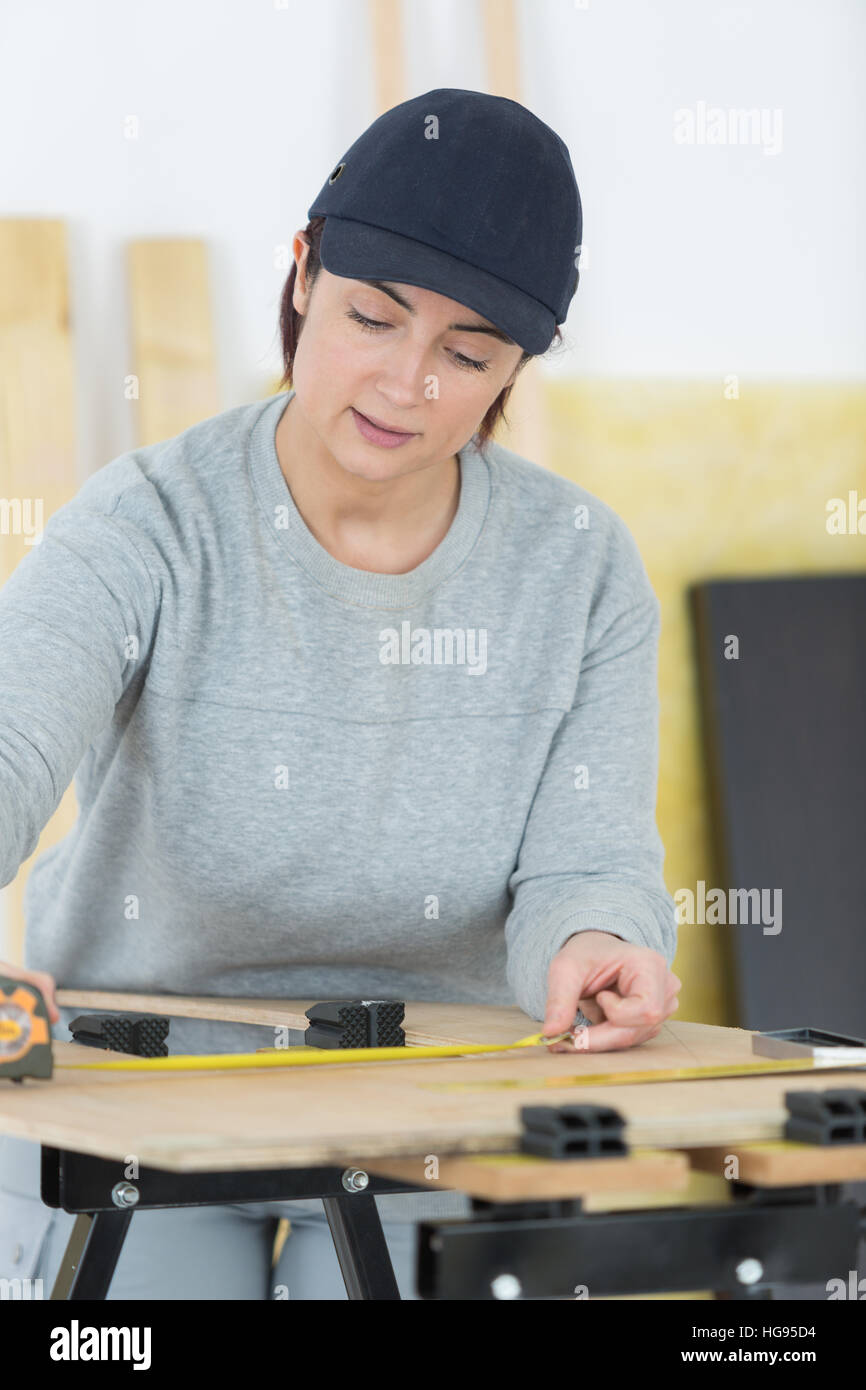 woman measuring a plywood Stock Photo - Alamy