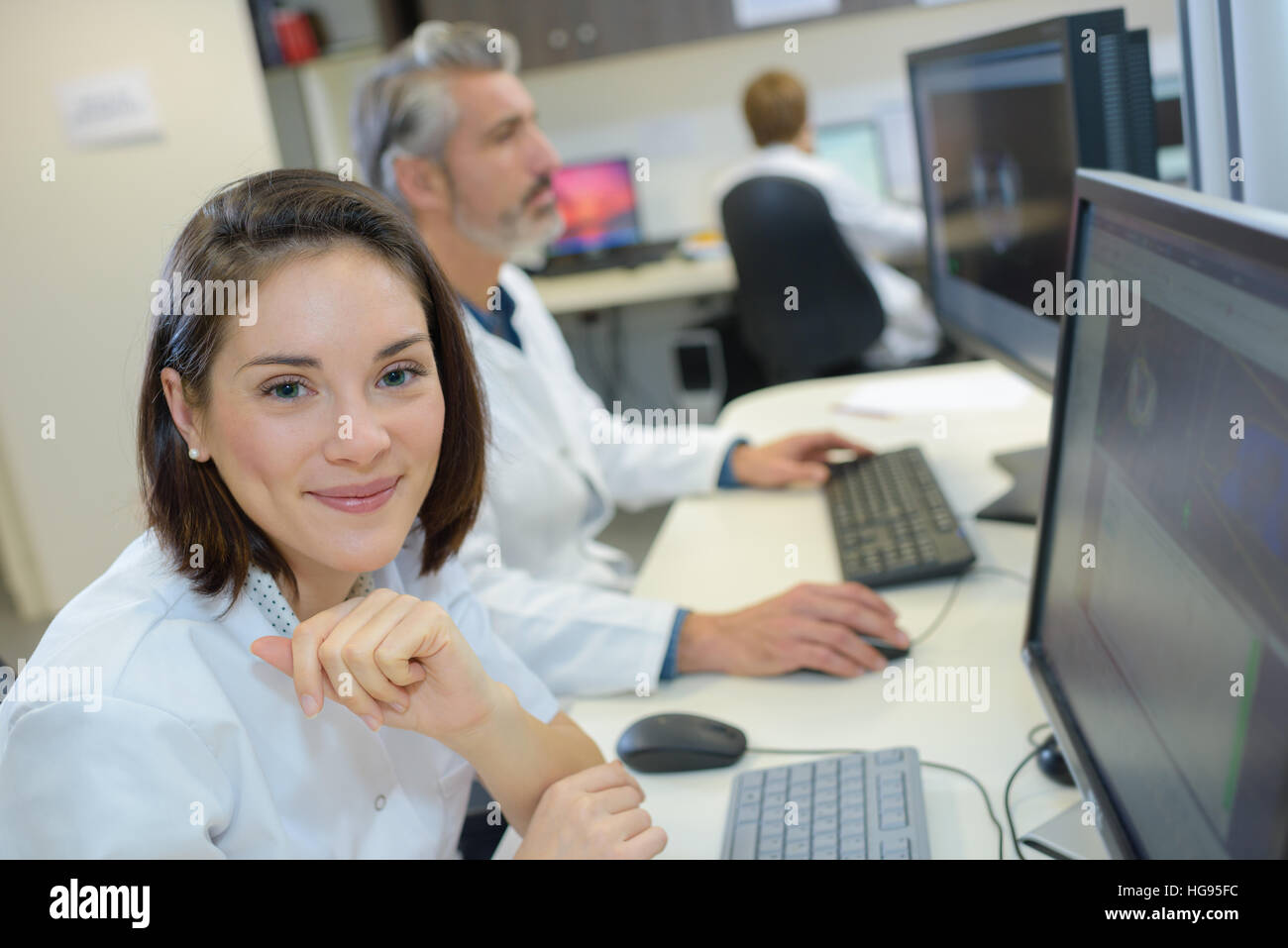 portrait of doctor looking at scans on computer Stock Photo - Alamy