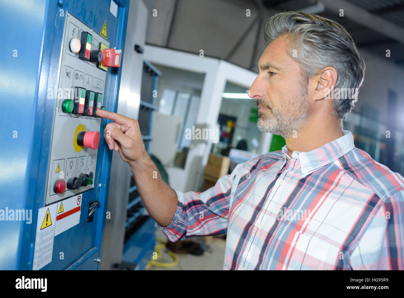 Man operating factory machine Stock Photo - Alamy