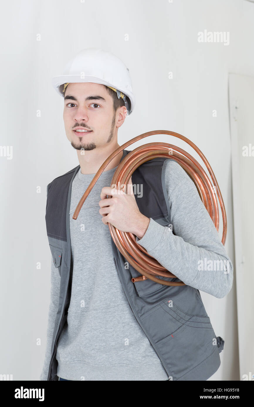 portrait of handsome plumber with adjustable wrench and pipe Stock ...