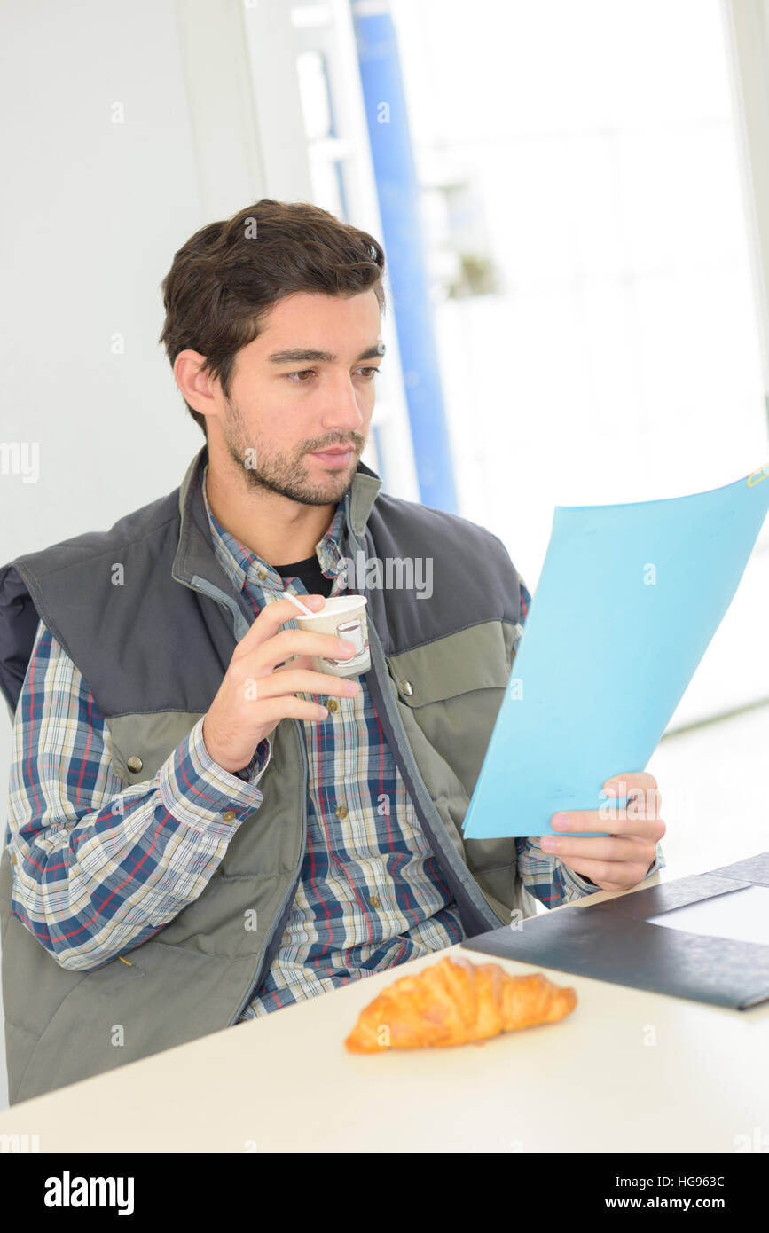 worker reading a paper Stock Photo - Alamy