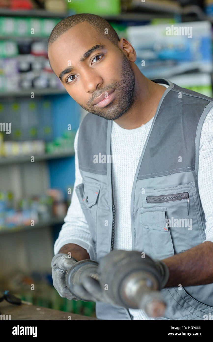 man holding a metal part Stock Photo - Alamy