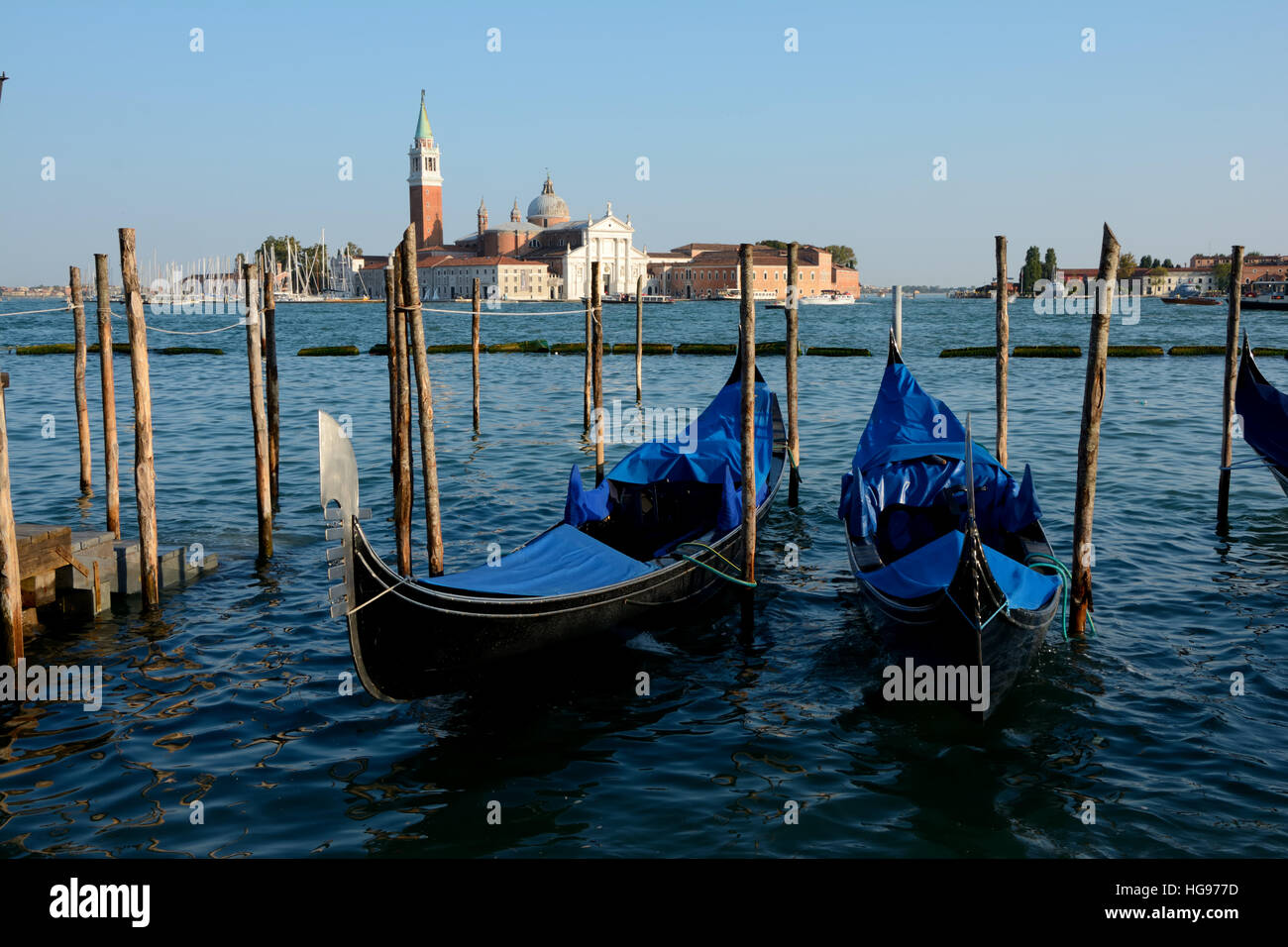Gondolas and wooden mooring piles in Venice, Italy Stock Photo - Alamy