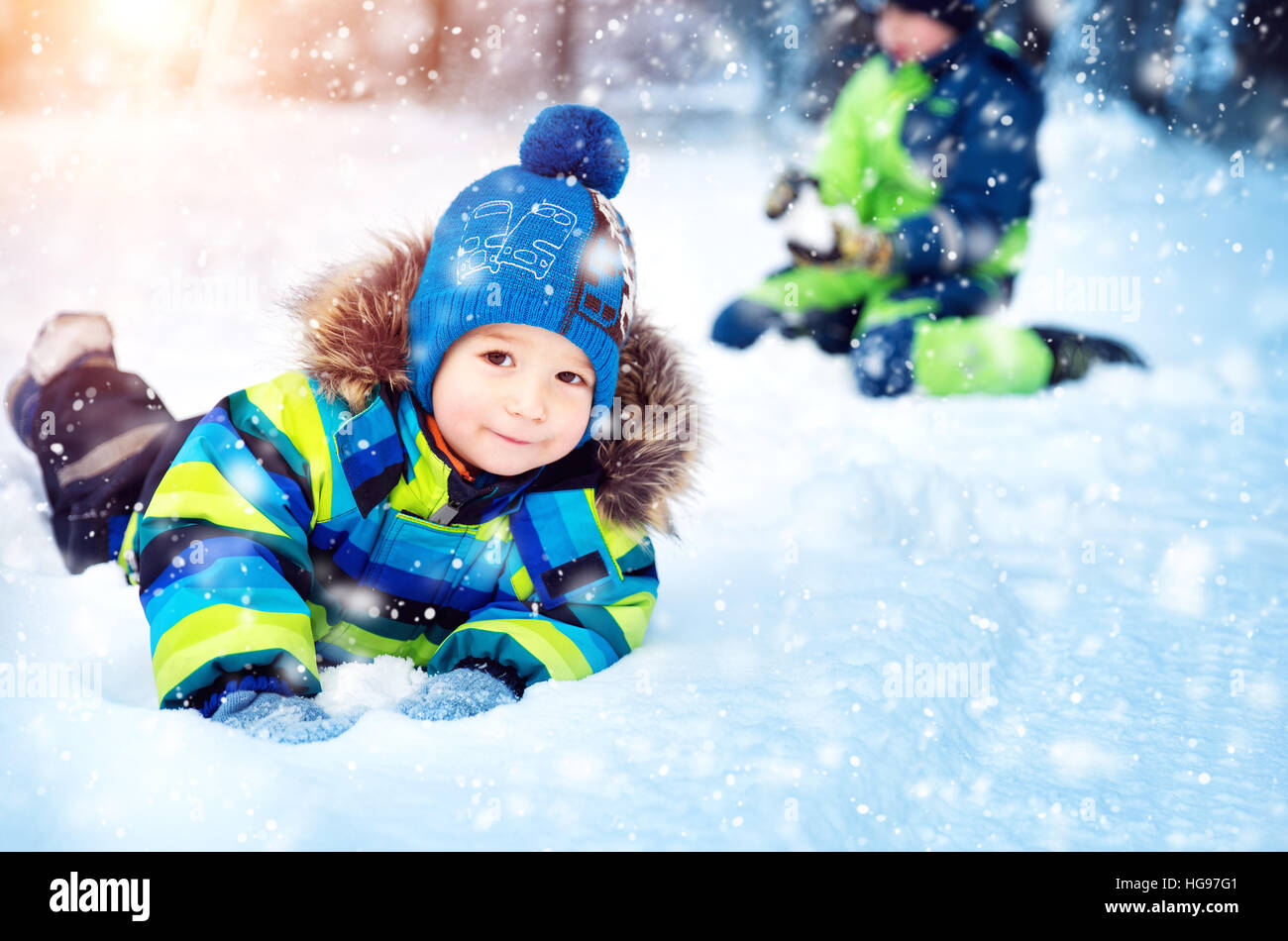 Children playing in snow at snowfall Stock Photo - Alamy