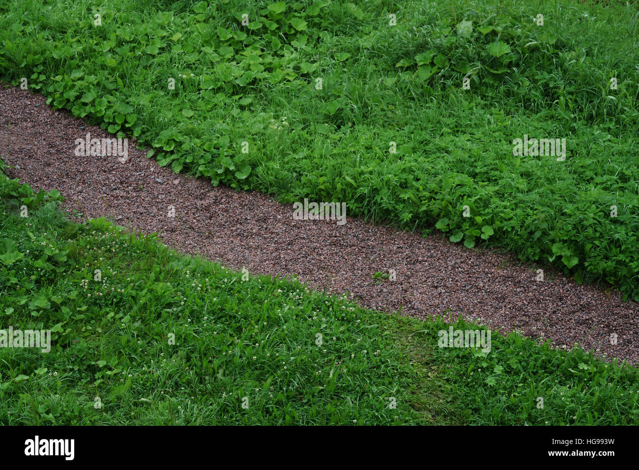 green grass with gravel diagonal path Stock Photo - Alamy