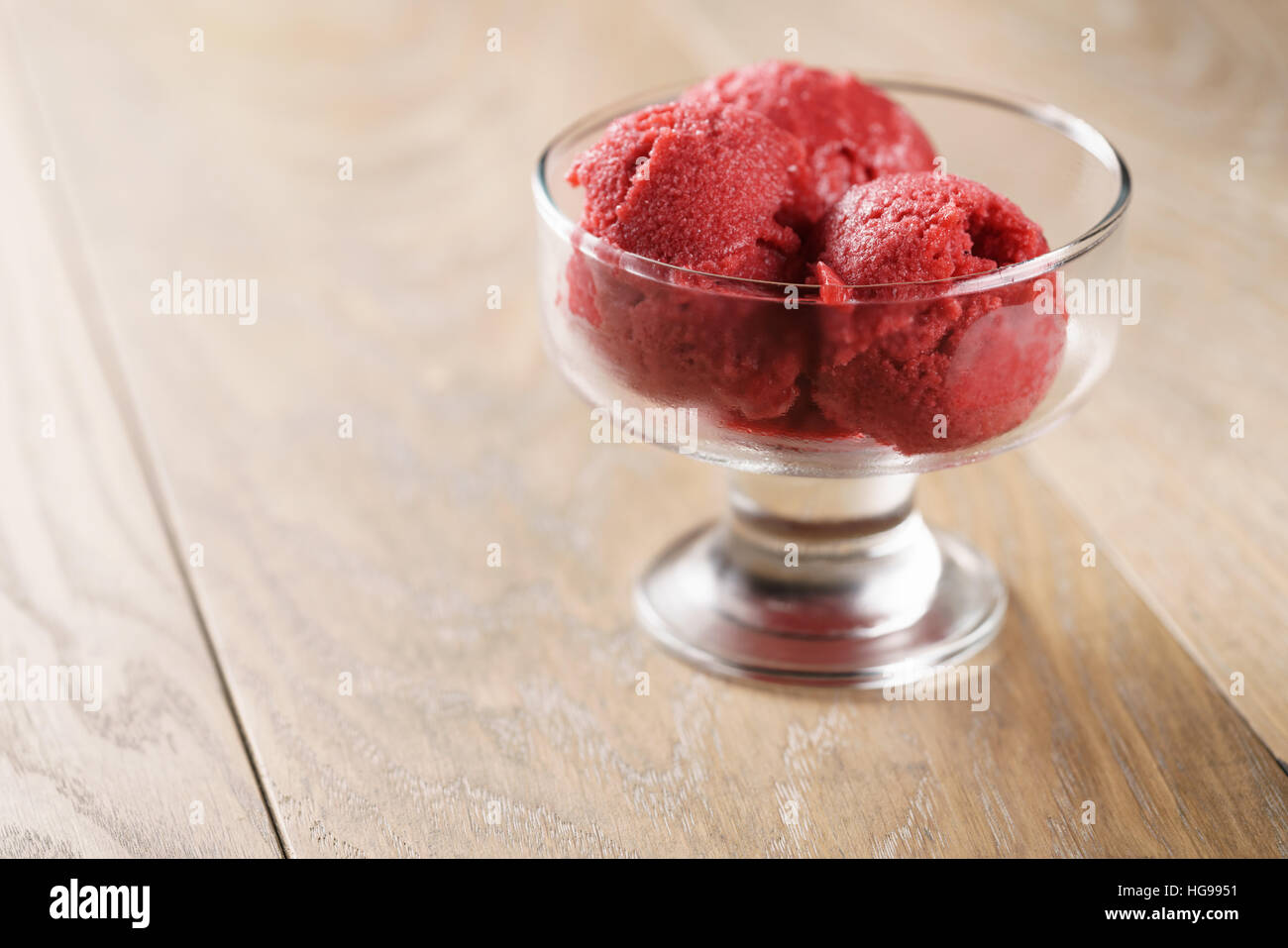 raspberry sorbet ice cream balls on wooden table Stock Photo - Alamy
