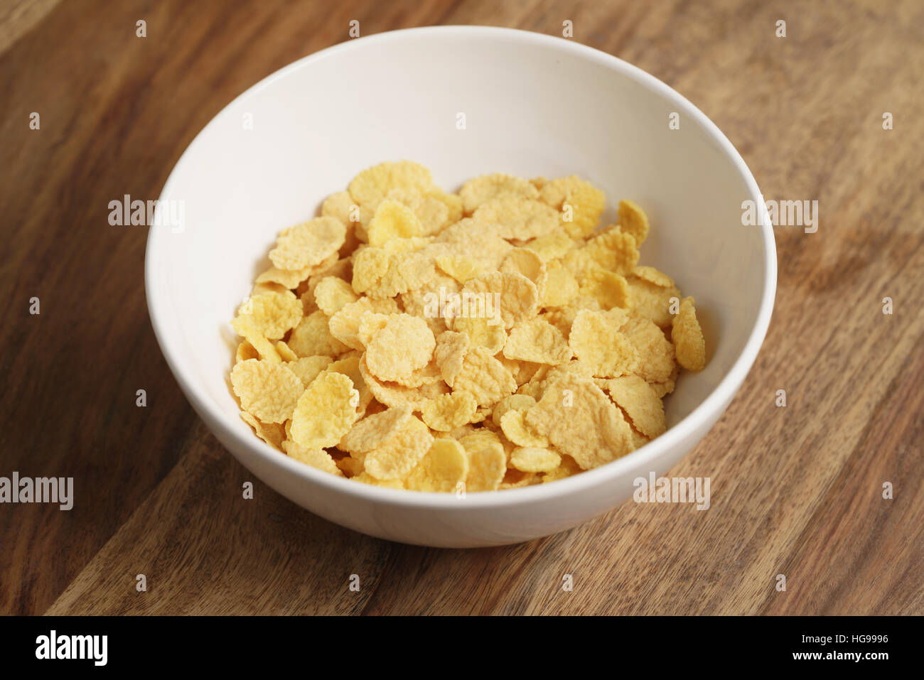 dry corn flakes in white bowl on wood table Stock Photo - Alamy