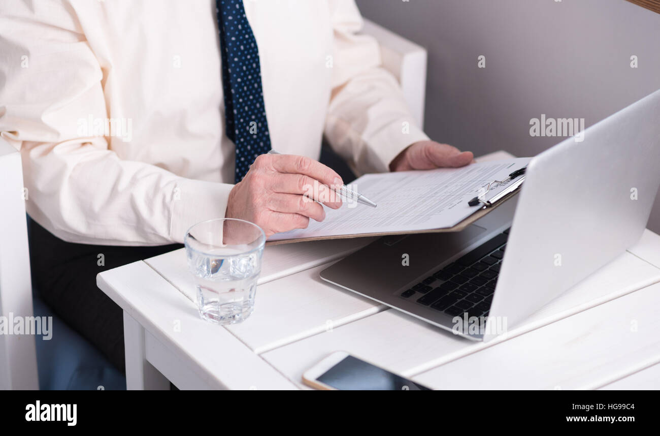 Handsome man reading his notes Stock Photo - Alamy