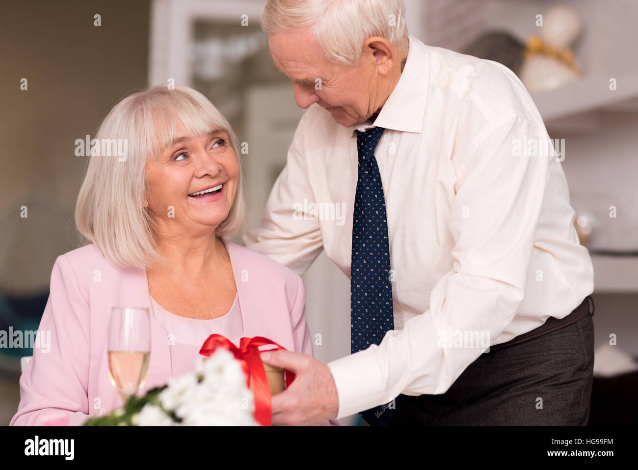 Magnificent smiling woman receiving a present Stock Photo - Alamy