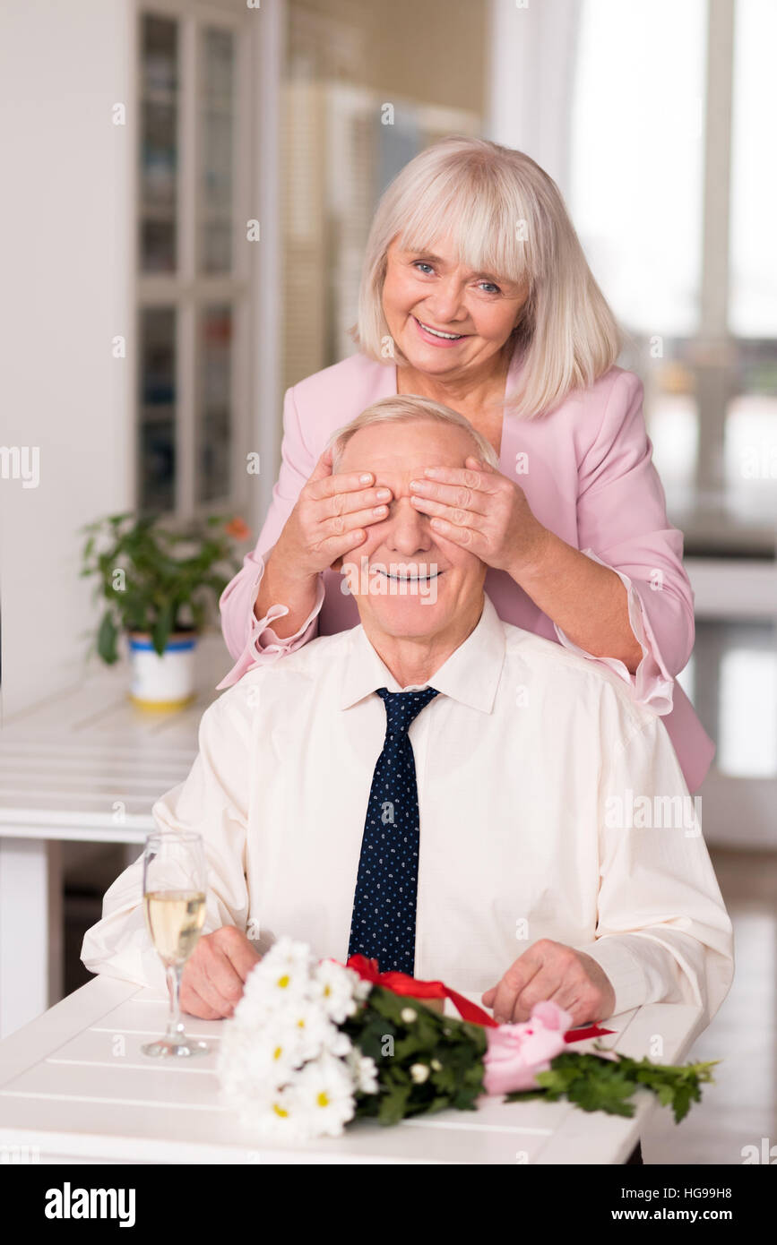 Lovable joyful lady surprising her man Stock Photo - Alamy