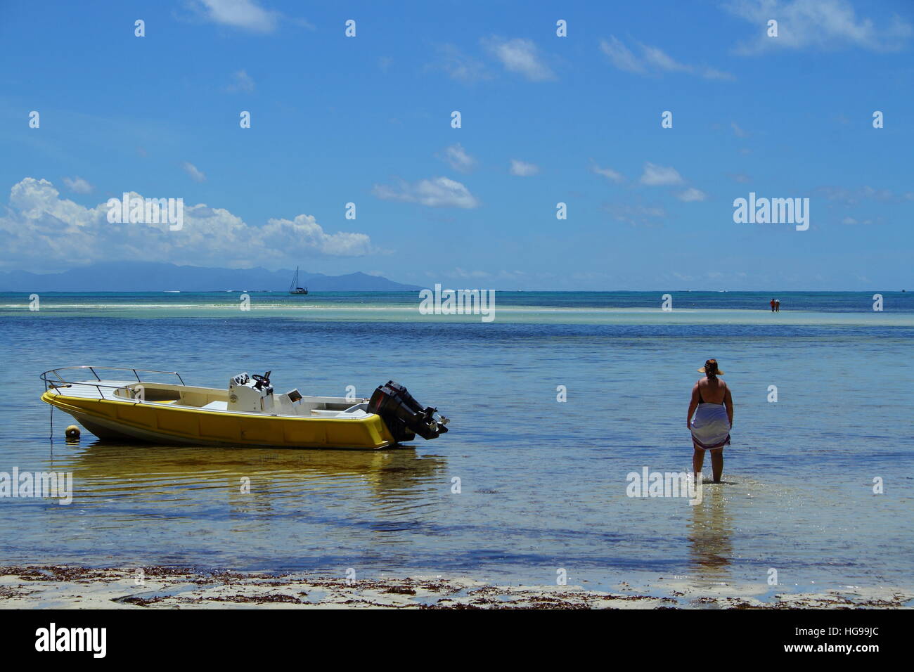 Tropical island beach holiday with a holidaymaker standing in the ...