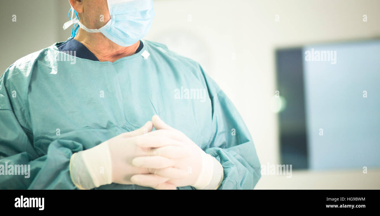 Surgeon in hospital surgery in sterile uniform "scrubs" and mask in ...