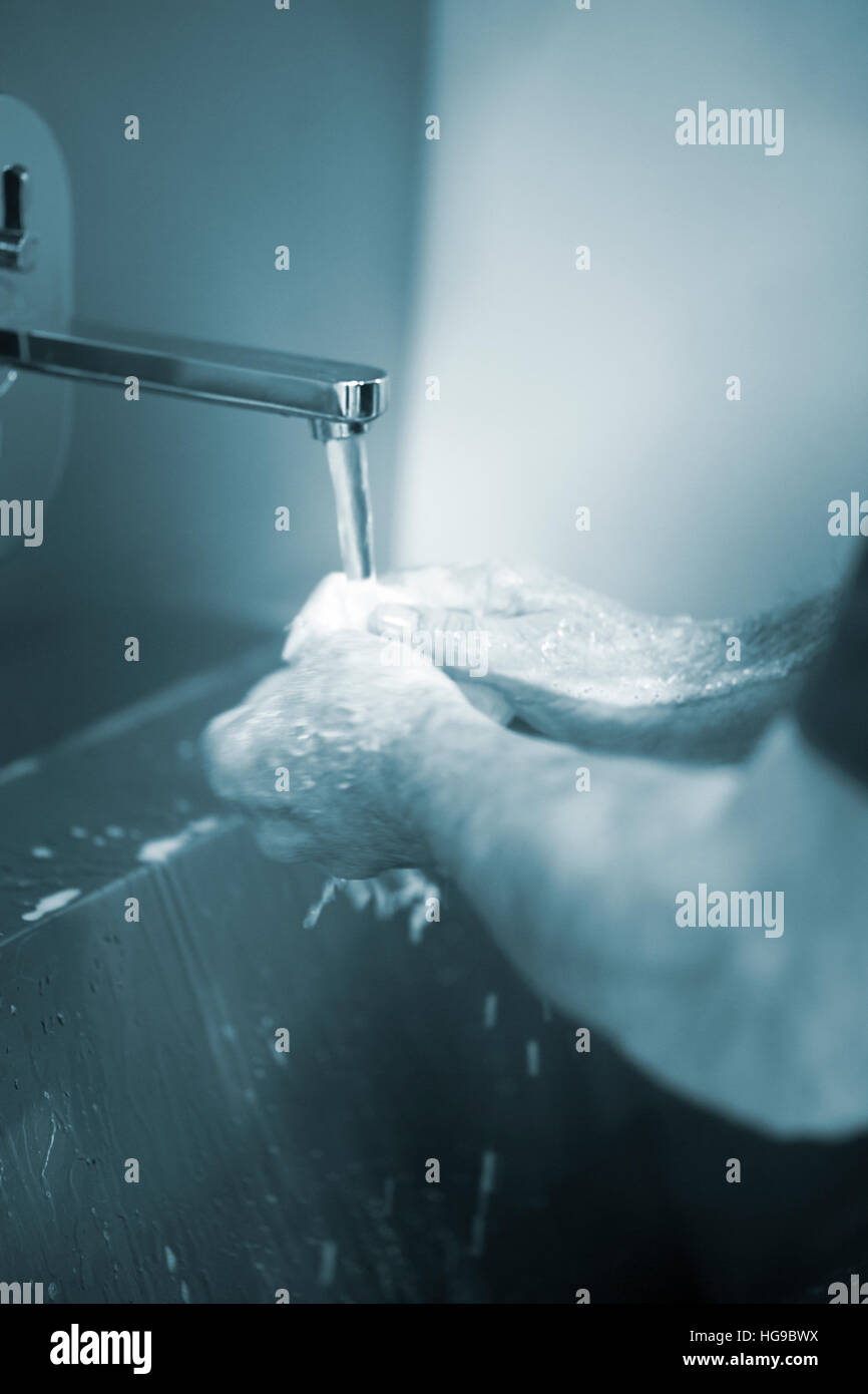 Surgeon in hospital surgery washing handsin sterile uniform "scrubs ...