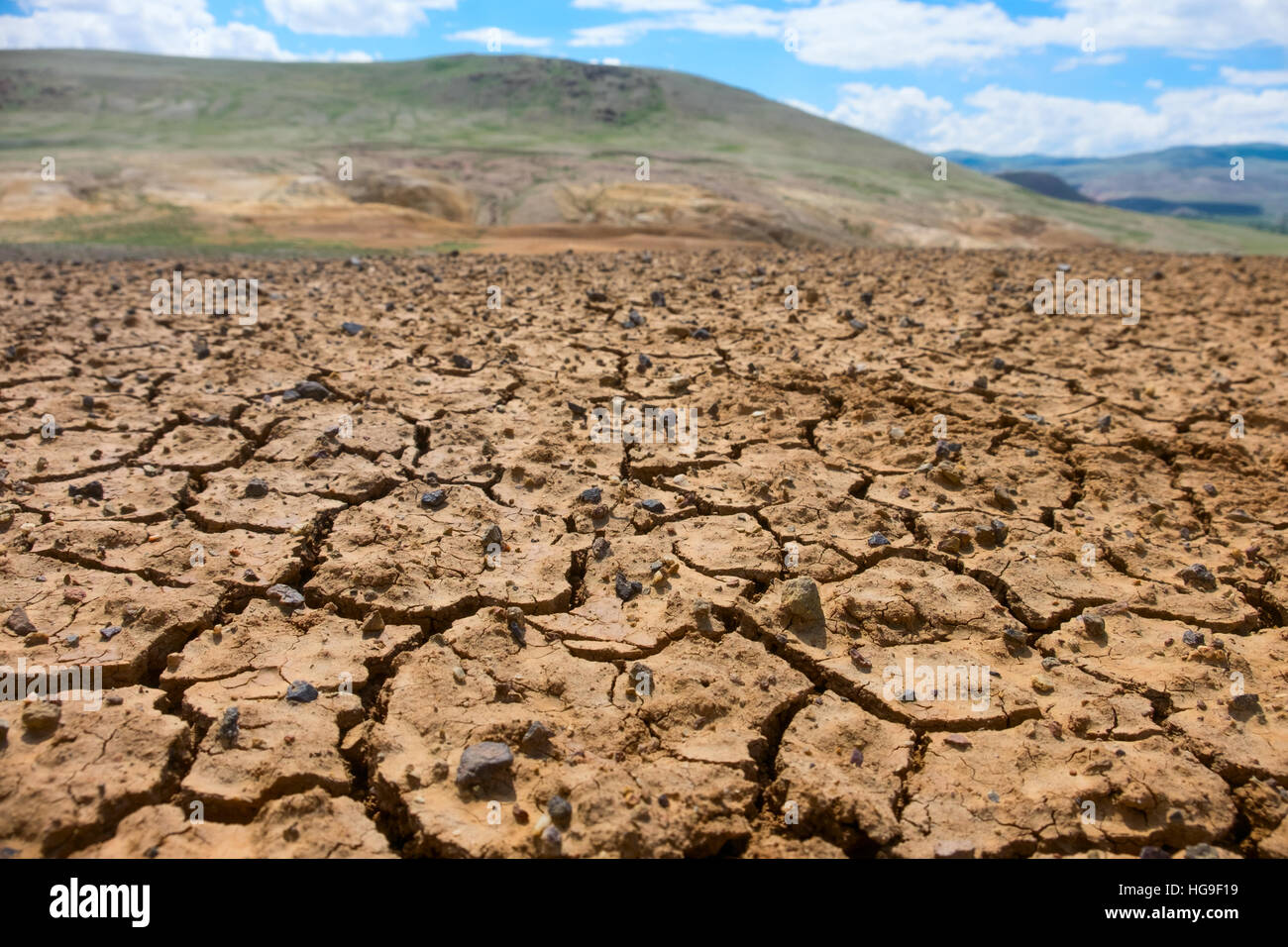 Desert and cracked clay soil is red Stock Photo - Alamy