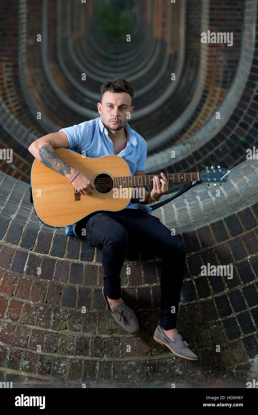 Singer, songwriter Jamie Mathias poses with his guitar for a shoot at ...