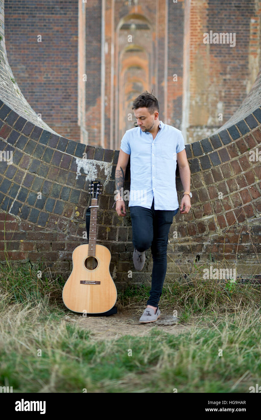 Singer, songwriter Jamie Mathias poses with his guitar for a shoot at ...