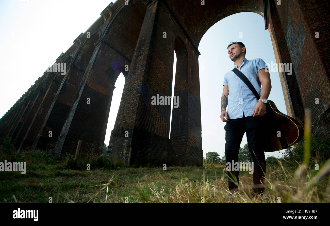 Singer, songwriter Jamie Mathias poses with his guitar for a shoot at ...