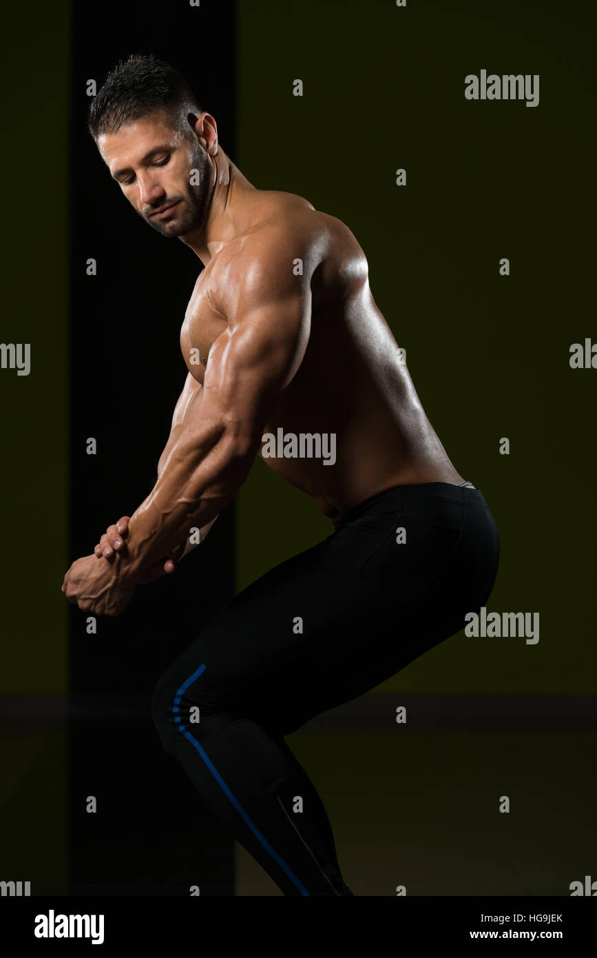 Healthy Man Standing Strong In The Gym And Flexing Muscles - Muscular ...
