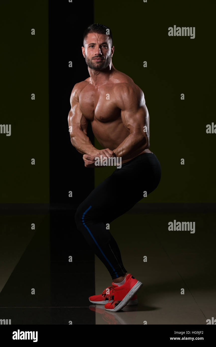 Healthy Man Standing Strong In The Gym And Flexing Muscles - Muscular ...