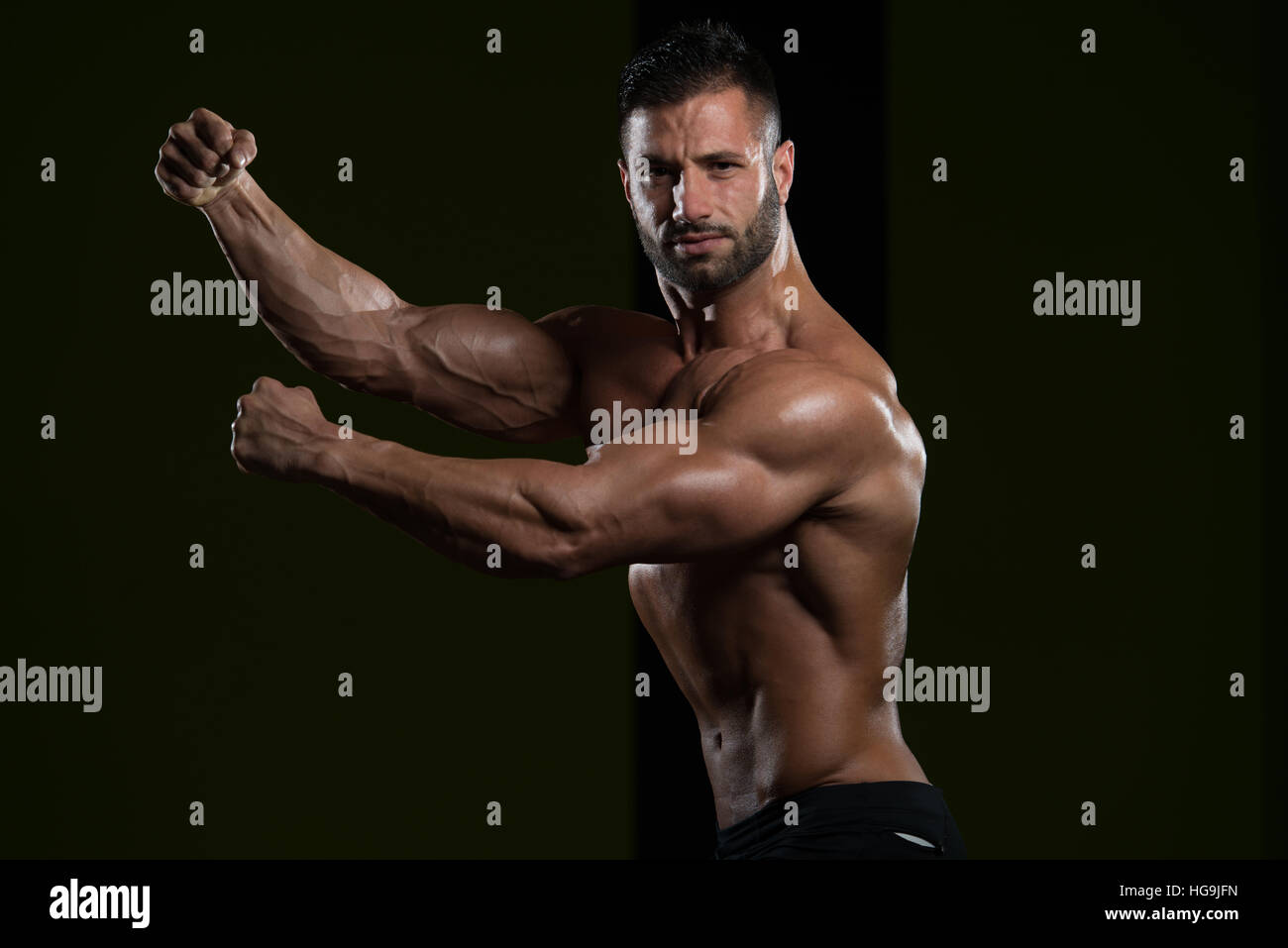 Healthy Man Standing Strong In The Gym And Flexing Muscles - Muscular ...