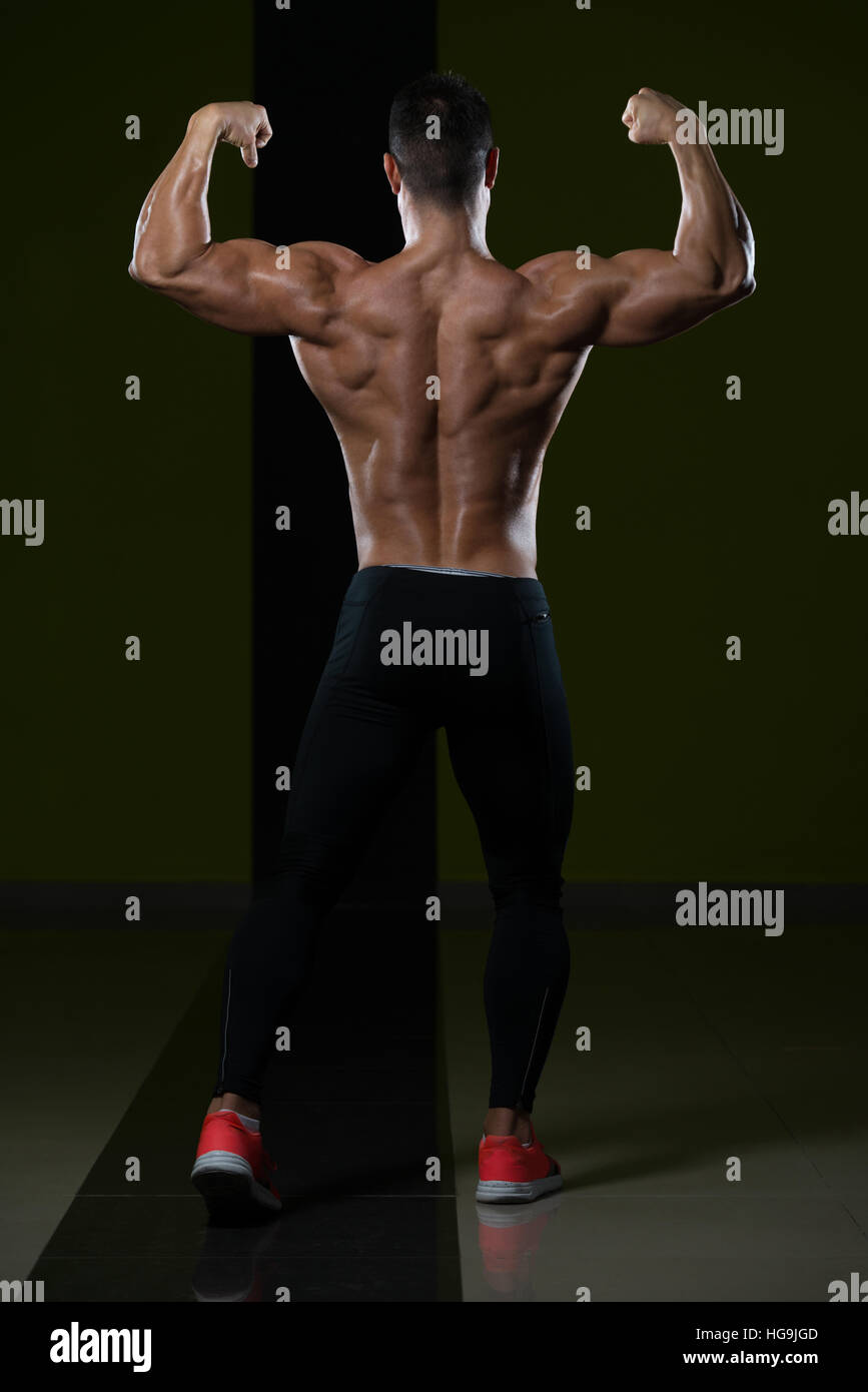 Healthy Man Standing Strong In The Gym And Flexing Muscles - Muscular ...