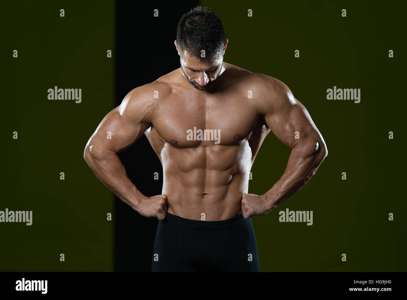 Healthy Man Standing Strong In The Gym And Flexing Muscles - Muscular ...