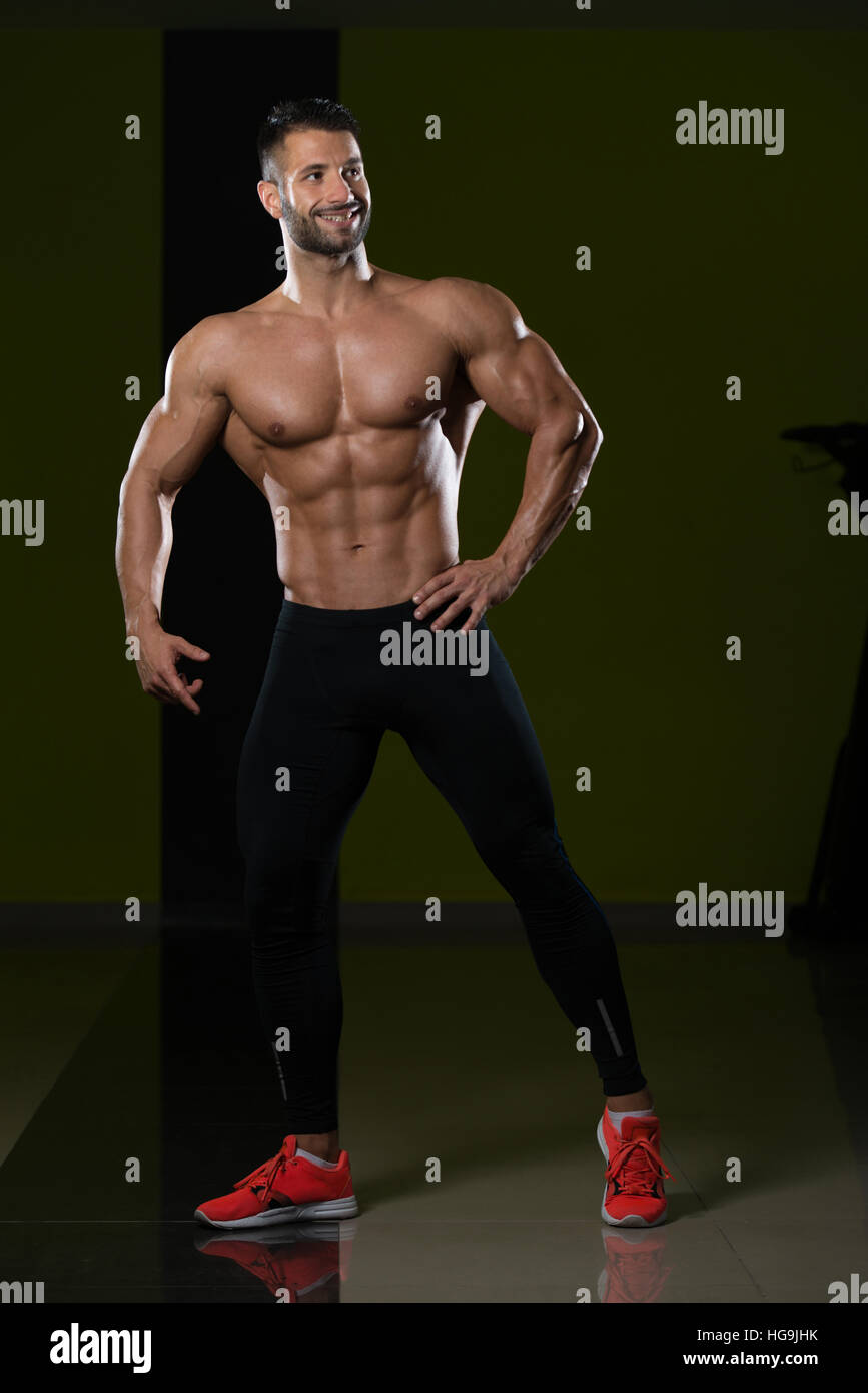 Healthy Man Standing Strong In The Gym And Flexing Muscles - Muscular ...