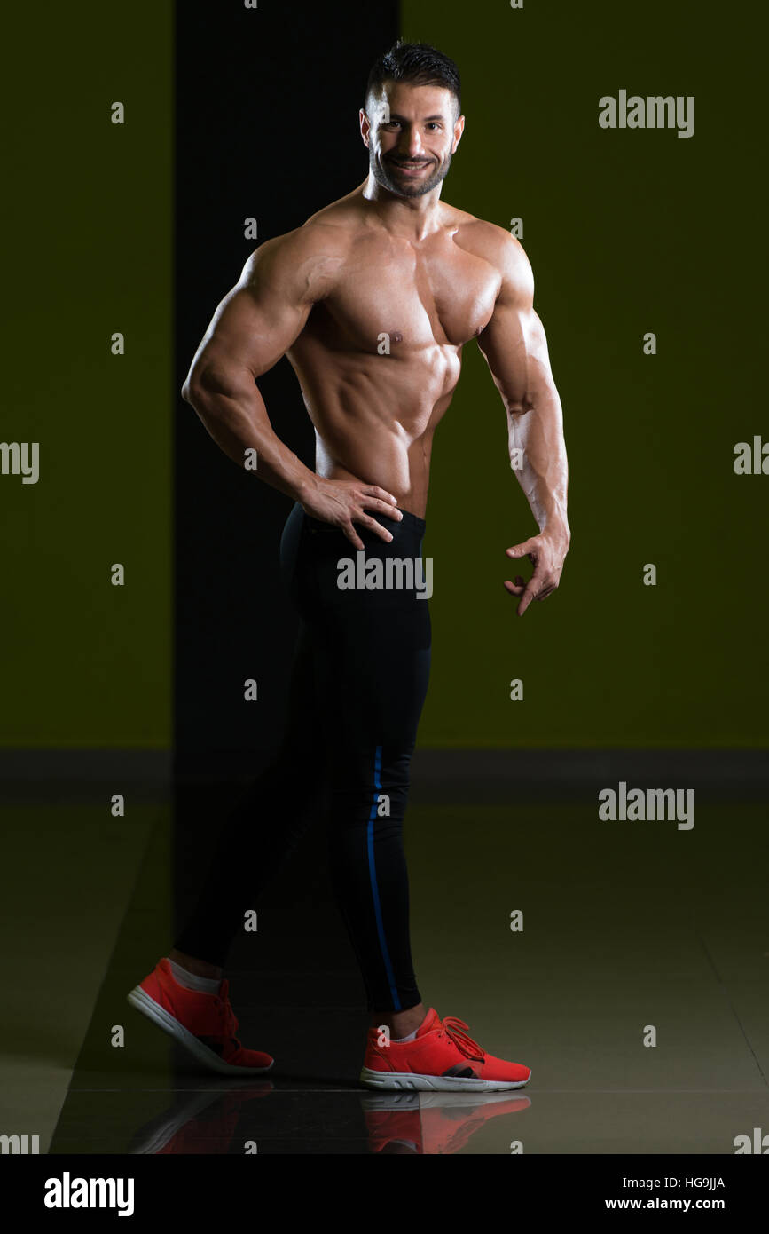 Healthy Man Standing Strong In The Gym And Flexing Muscles - Muscular ...