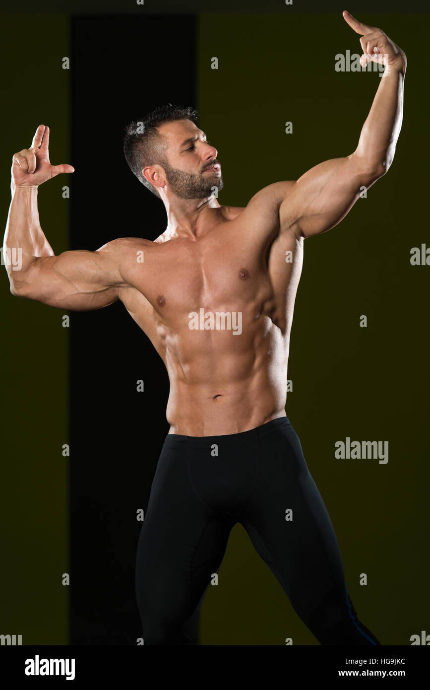 Healthy Man Standing Strong In The Gym And Flexing Muscles - Muscular ...