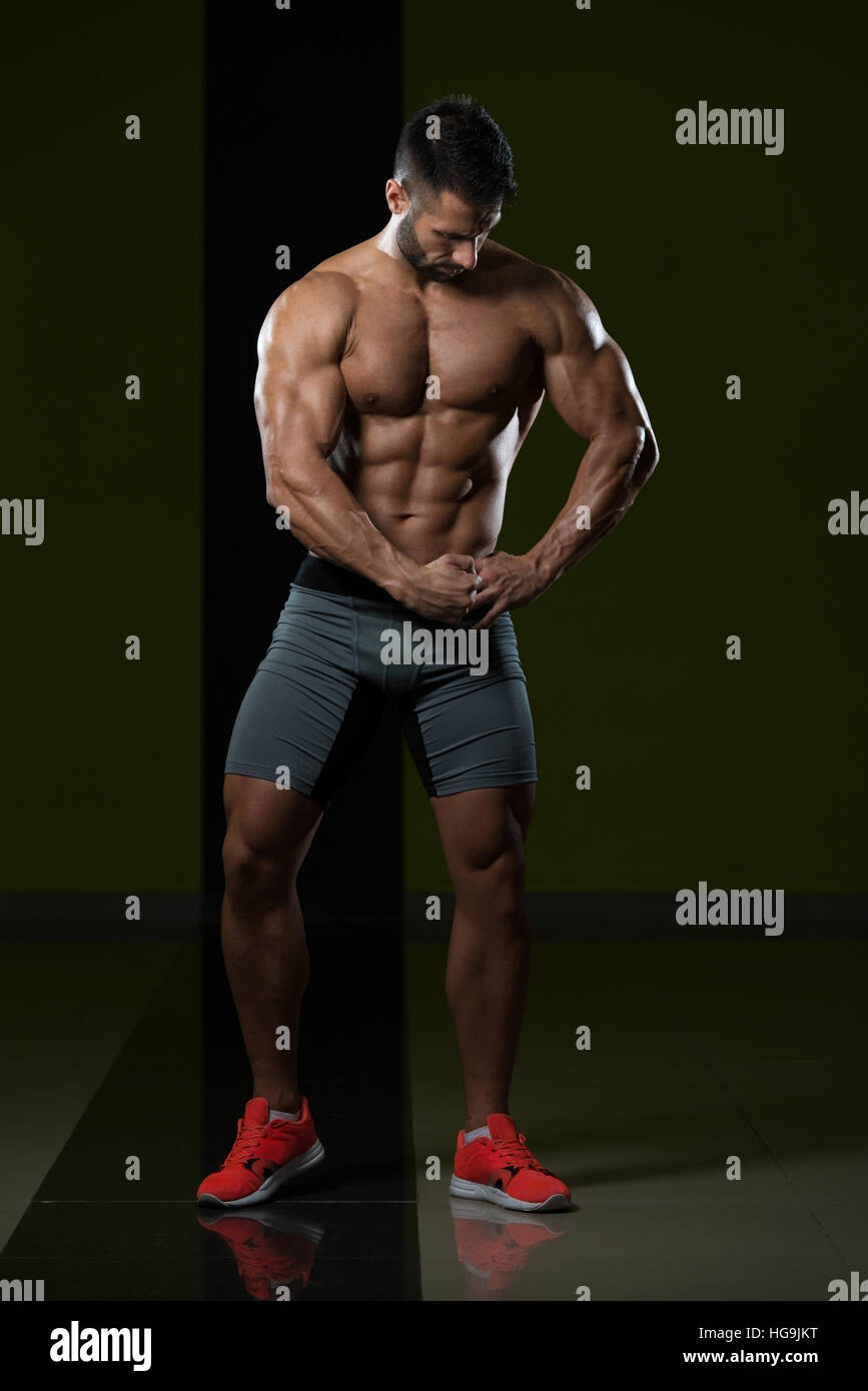 Healthy Man Standing Strong In The Gym And Flexing Muscles - Muscular ...