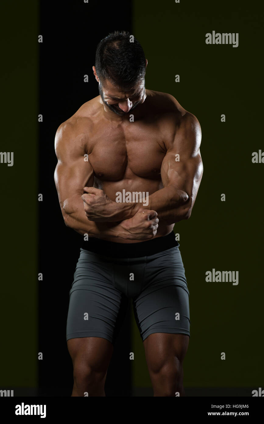 Healthy Man Standing Strong In The Gym And Flexing Muscles - Muscular ...