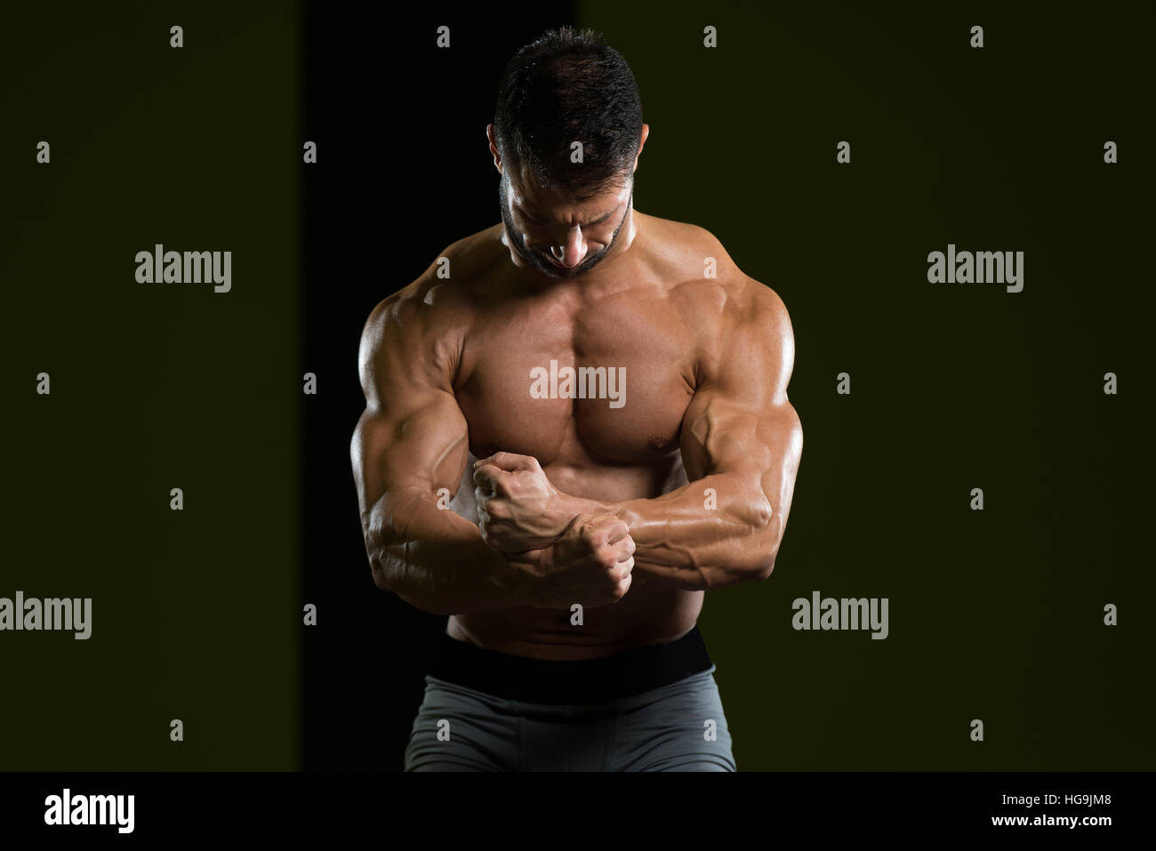 Handsome Man Standing Strong In The Gym And Flexing Muscles - Muscular ...