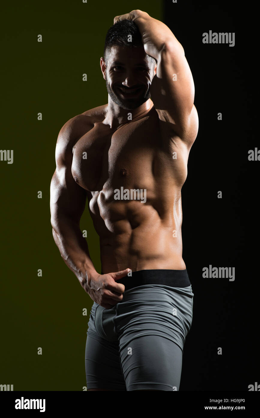 Healthy Man Standing Strong In The Gym And Flexing Muscles - Muscular ...