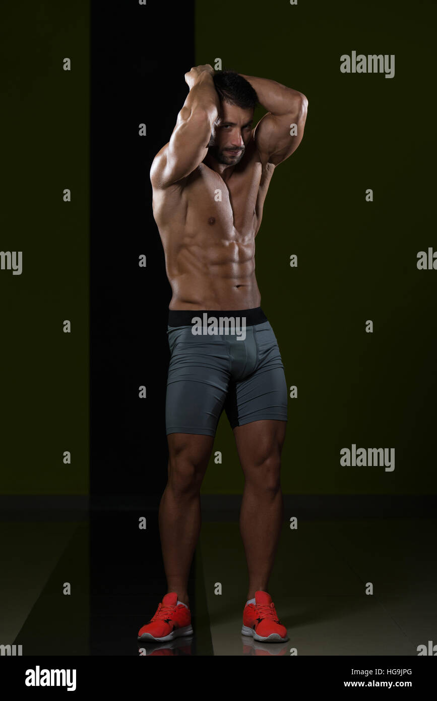 Healthy Man Standing Strong In The Gym And Flexing Muscles - Muscular ...