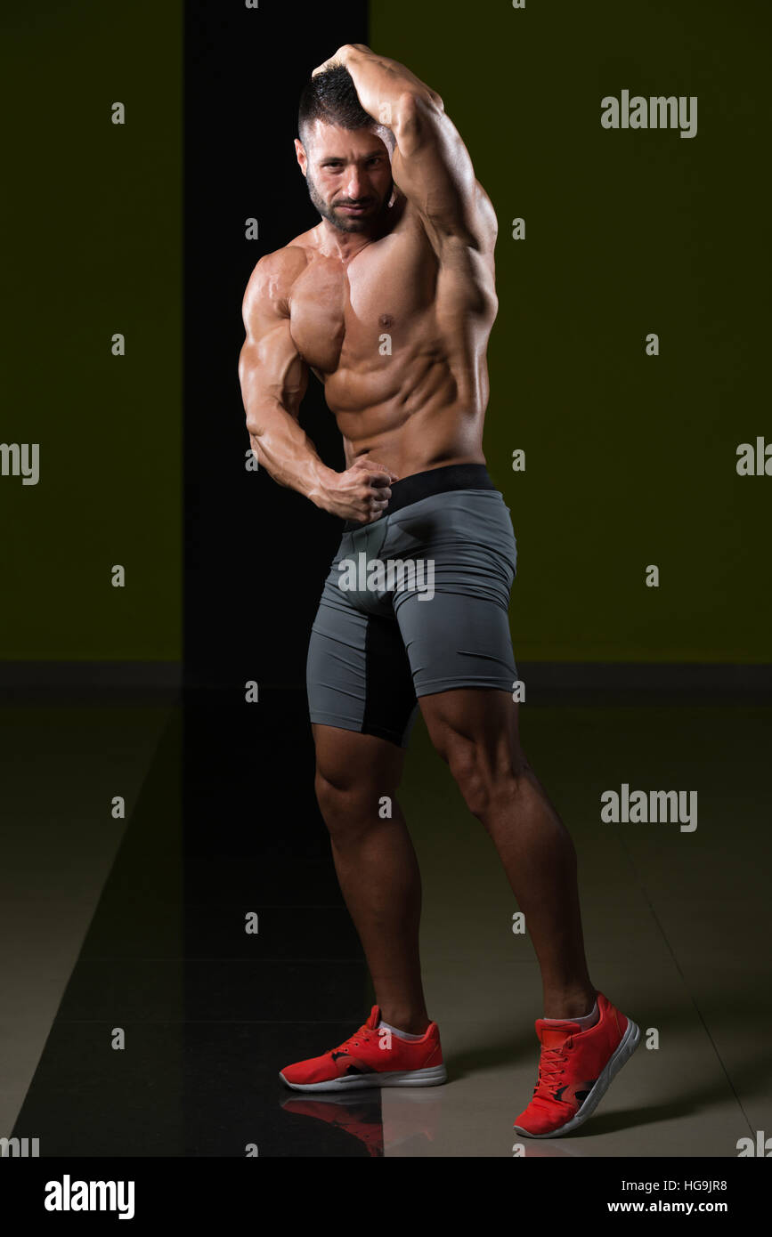 Healthy Man Standing Strong In The Gym And Flexing Muscles - Muscular ...