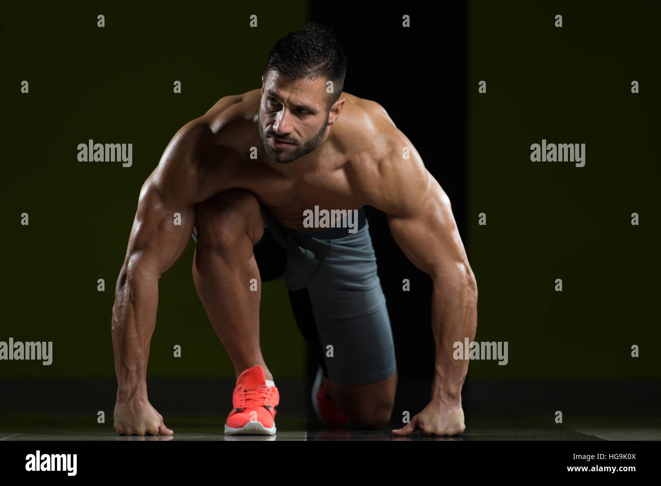 Strong Muscular Men Kneeling On The Floor - Almost Like Sprinter ...