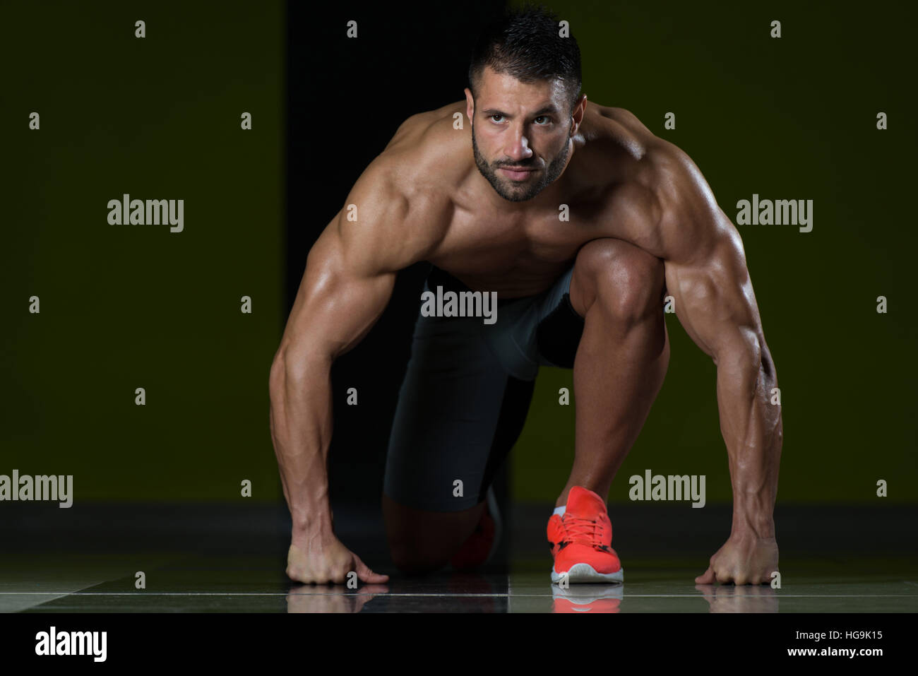 Strong Muscular Men Kneeling On The Floor - Almost Like Sprinter ...