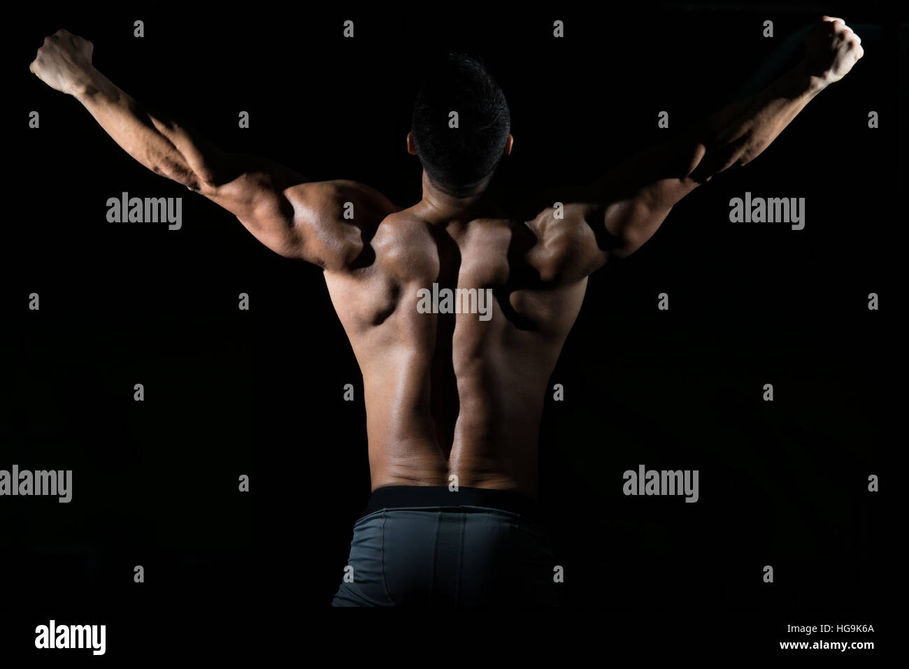Handsome Man Standing Strong In The Gym And Flexing Muscles - Muscular ...