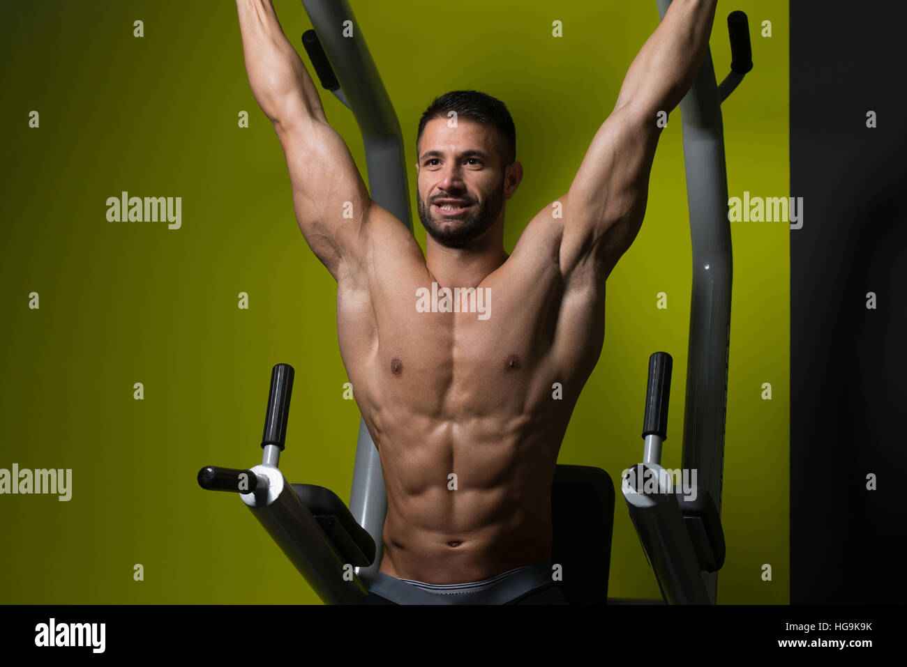Muscular Man Performing Hanging Leg Raises Exercise - One Of The Most ...