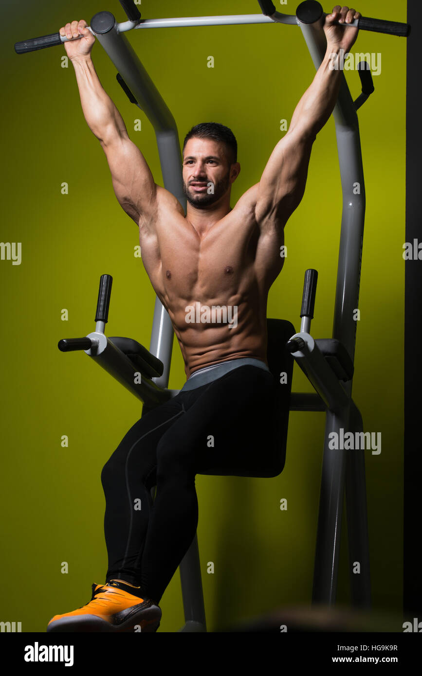 Muscular Man Performing Hanging Leg Raises Exercise - One Of The Most ...