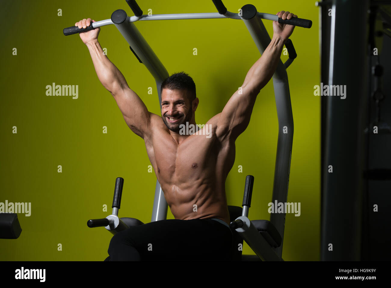 Muscular Man Performing Hanging Leg Raises Exercise - One Of The Most ...
