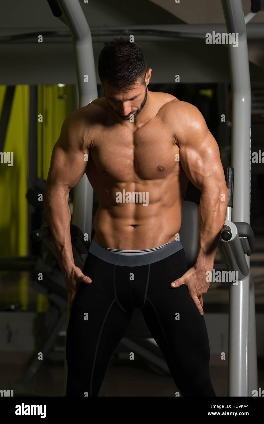 Healthy Man Standing Strong In The Gym And Flexing Muscles - Muscular ...